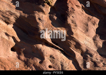 Red rock wind worn texture at sunrise Stock Photo - Alamy