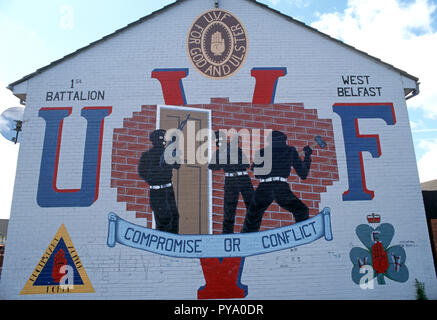 A masked Ulster Defence Association (UDA) colour party leads hundreds ...