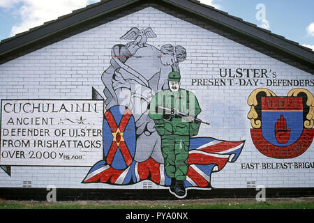 A masked Ulster Defence Association (UDA) colour party leads hundreds ...