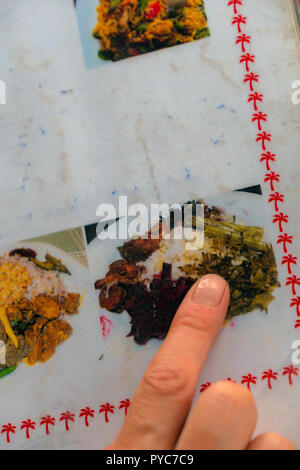 Finger pointing at cafe menu Stock Photo - Alamy