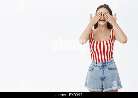 Indoor shot of expressive excited attractive dark-skinned adult woman ...