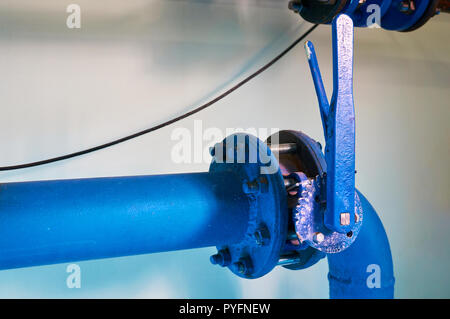 Gate valves installed on pipes painted in blue. Industrial background ...