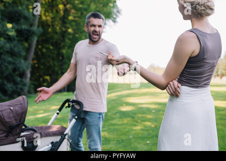 Woman smoking near baby Stock Photo - Alamy