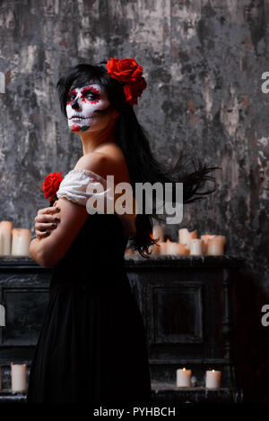 Photo of zombie woman with white face and red flower on her head Stock ...
