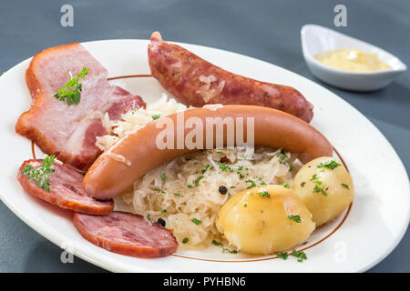 Choucroute garnie, a typical alsacian plate, with sausages, bacon ...