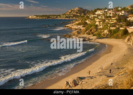 Swimmers on beach at sunrise, Punta Palmilla in distance, Gulf of ...