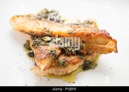 Sections of ray wings from an Undulate ray, Raja undulata, frying in ...