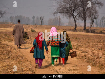A Kashmiri farmer return to his home after day long work at agriculture ...