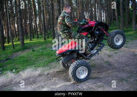 Russian men ride all-terrain quad bike vehicles ATV in a muddy ...
