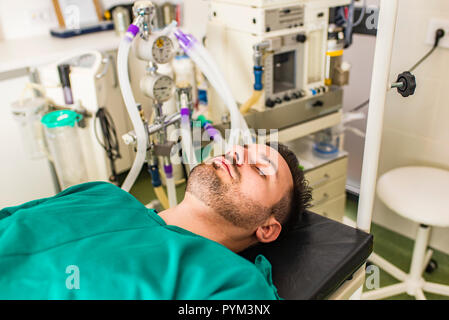 Young man lies on the operating table at the clinic Stock Photo - Alamy