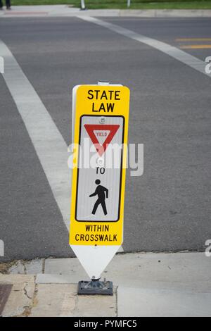 Cross Walk Sign With Cars Driving in the Background Stock Photo - Alamy
