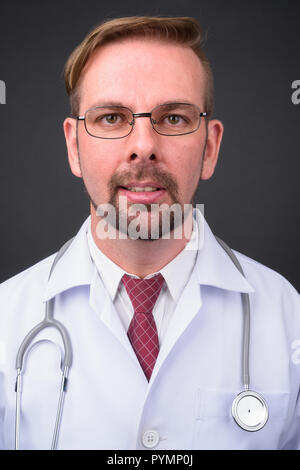 Blond bearded man doctor with goatee against gray background Stock ...