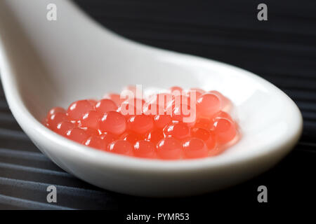 Molecular melon caviar balls on spoon Stock Photo - Alamy