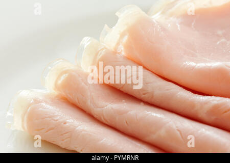Ham folded on white plate close up Stock Photo - Alamy