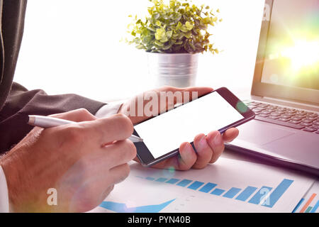 Businessman working and consulting a mobile in an office close up ...