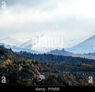 Contrast between autumn hills and snow covered high mountains Stock ...