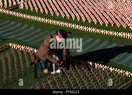 Captain Gary Rattray from 2 Scots Royal Regiment of Scotland lays a ...