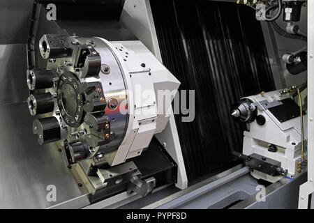 Rotating head at CNC lathe in workshop Stock Photo - Alamy