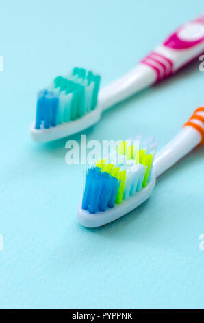 Two toothbrushes lie on a pastel pink background. Top view, flat lay ...