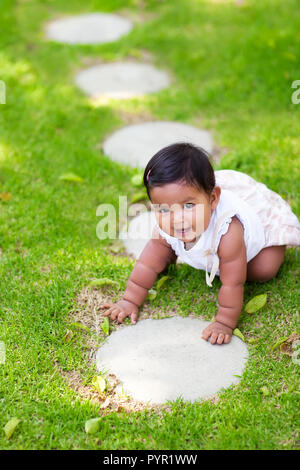 Adorable hispanic baby crawling on floor at kindergarten Stock Photo ...
