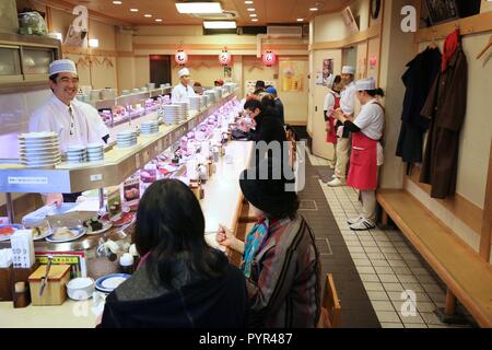 interior of a typical Japanese conveyor belt sushi restaurant. People ...