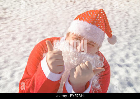 Funny fat man dressed as santa claus is sitting on the snow Stock Photo ...