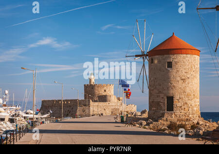 Windmill and fortified lighthouse in Rhodes town marina pier Stock ...