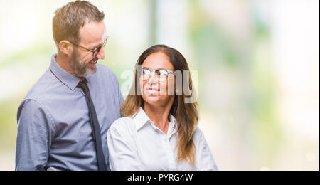 Middle age hispanic couple wearing christmas hat over isolated ...