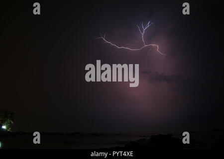 Small lightning strike in sky at clouds Stock Photo - Alamy
