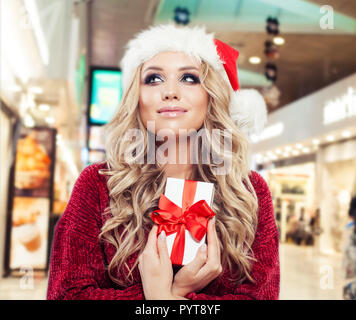 Cheerful woman in santa hat holding empty driving license isolated on ...