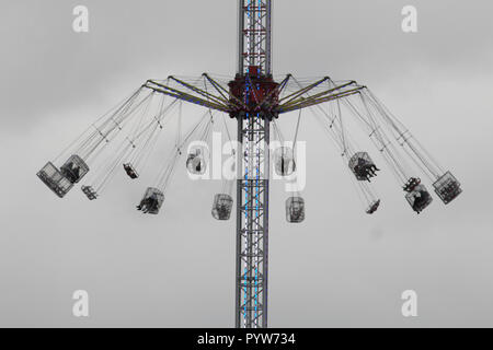 People enjoy the high-flying swings at the Funfair at the coastal ...