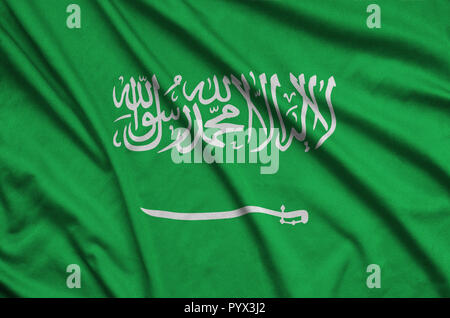 Saudi Arabia flag with big folds waving close up under the studio light ...