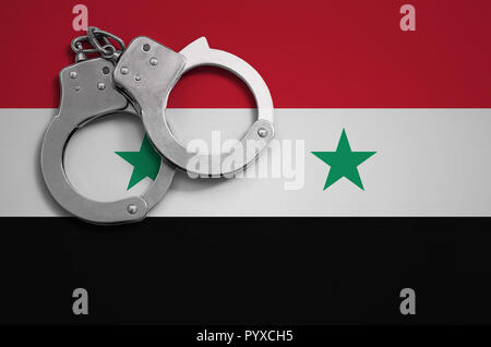 Syria flag and police handcuffs. The concept of observance of the law ...