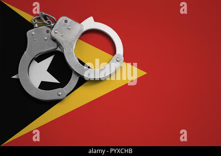 Timor Leste flag and police handcuffs. The concept of observance of the ...