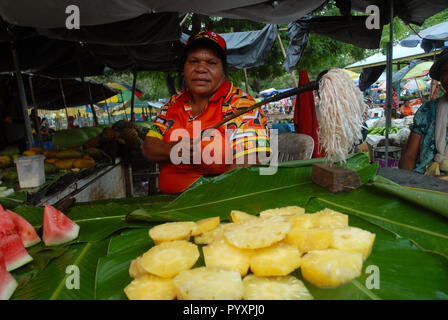 Lady selling pineapple at Boroko market, Port Moresby, Papua New Guinea ...