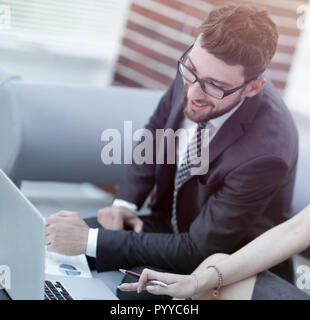 manager and client browsing information on the laptop Stock Photo - Alamy