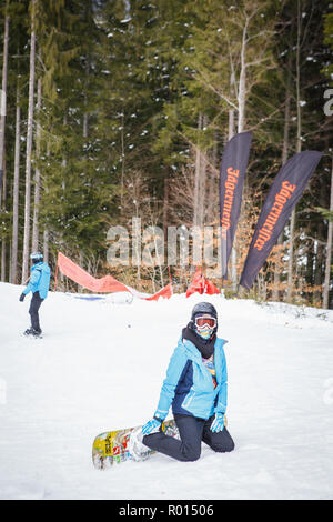 BUKOVEL,UKRAINE-20 MARCH,2018: Snowboard contest in winter park.Young ...