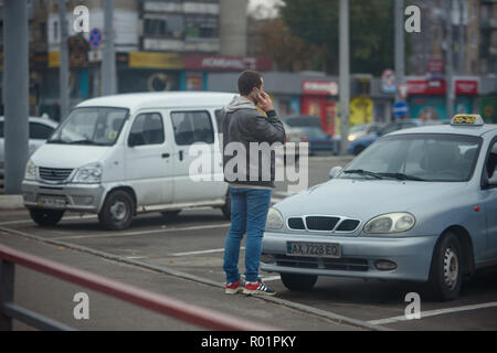 Ukrainian people get into a taxi in front of Roma Ostiense bus station ...