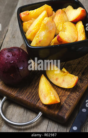 Sliced nectarine on dark wooden cutting board Stock Photo - Alamy