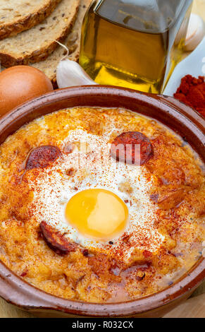 Garlic and bread soup (Castilian, from Spain) in clay pot and its main ...