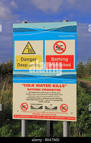 Sign warning of deep cold water in a flooded pit at Clee Hill Quarry in ...