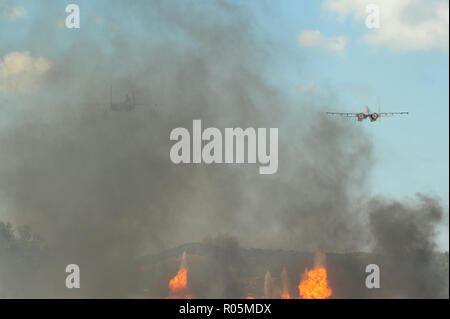 Two jet fighter aircarft seen in between smoke and fire after bombing ...