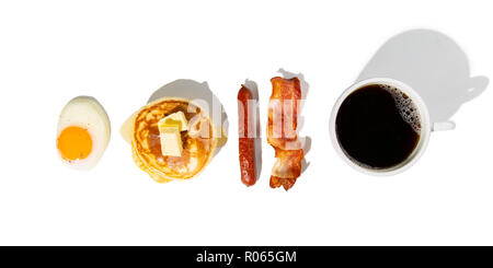 Creative layout - breakfast essentials - eggs, pancakes, bacon, on ...