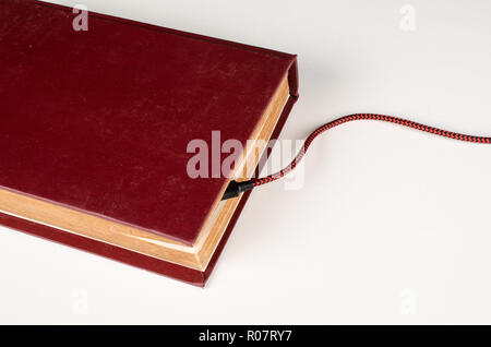 Old book with a battery charging cable, a concept of analog versus ...