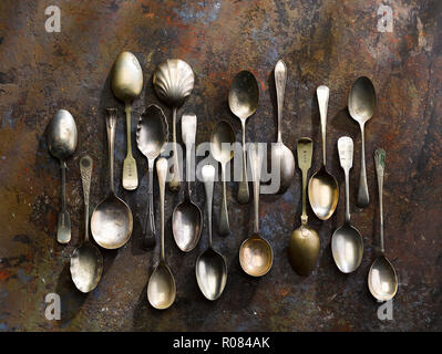 Group of steel metal spoons in tray with mat Stock Photo - Alamy