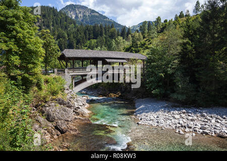 Wooden bridge over the Ostrach in the autumnal Ostrachtal, Allgaeu ...