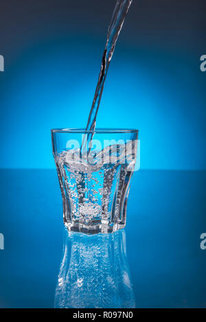 pouring clear water into a glass beaker Stock Photo - Alamy
