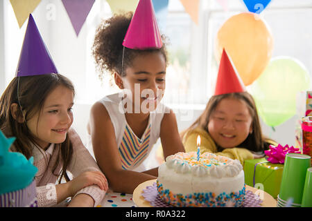A Group of three adorable kids having fun at birthday party Stock Photo ...