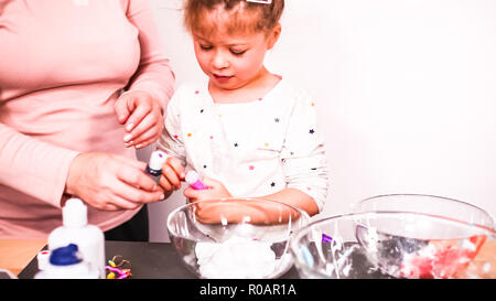 Step by step. Mother and daughter making colorful fluffy slime Stock ...