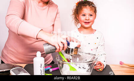 Step by step. Mother and daughter making colorful fluffy slime Stock ...